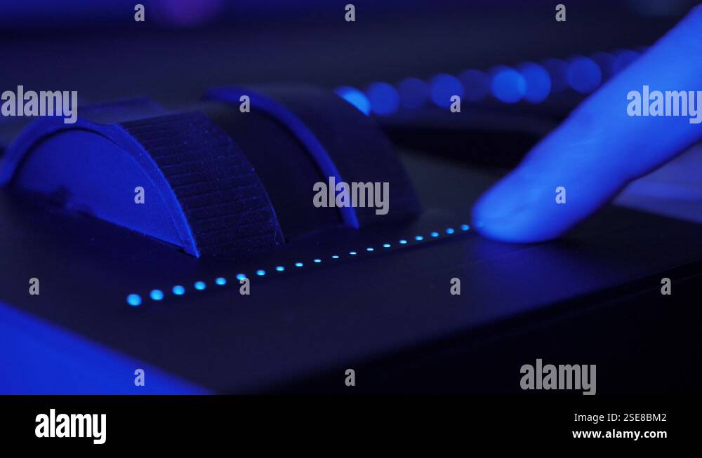 Adjusting volume on piano keyboard touch panel slider. Man using touch ...