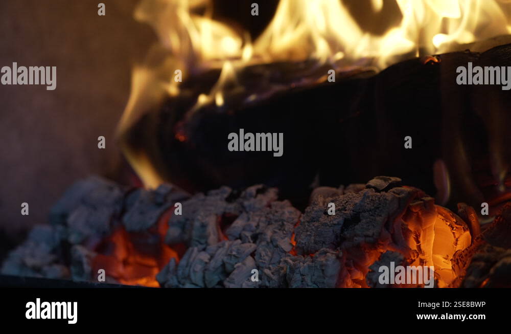 Split Firewood With Burning Fire And Charcoal. - close up Stock Video ...