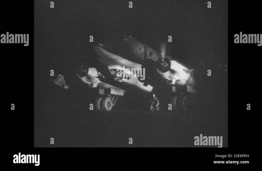 1940s: Night shot, plane propellers starting. Plane on runway. Crew ...