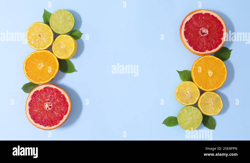 Fresh citrus fruits and green leaves move on left and right side. Stop ...