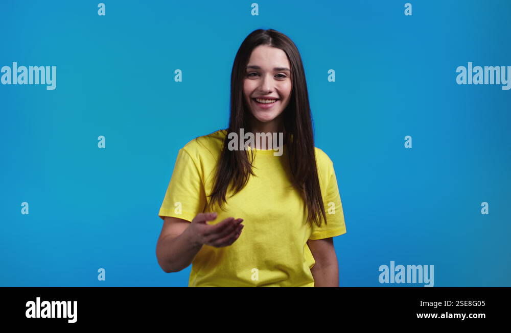 Young woman showing - Hey you, come here. Pretty girl in yellow wear ...