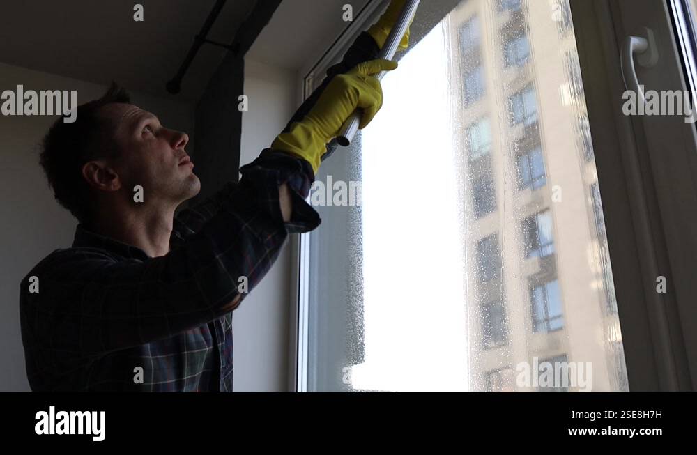 Man Cleaning Window At Home. A Worker Washes Windows In Office Stock ...