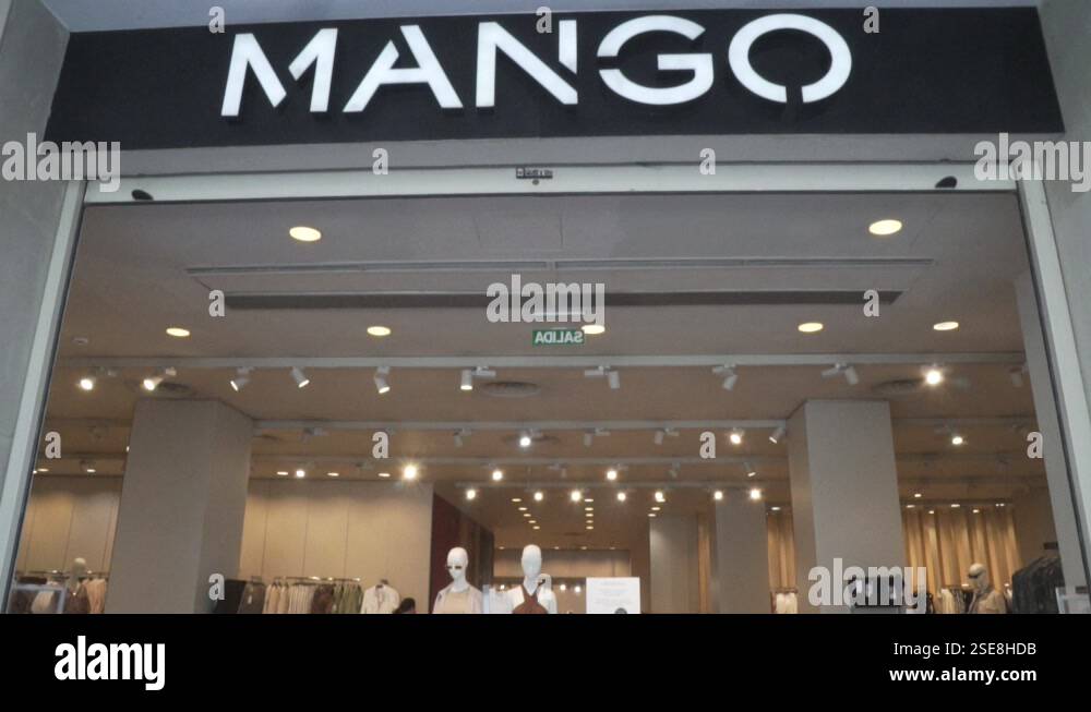 Slow tilt up of a Mango store entrance with a big banner on top Stock ...