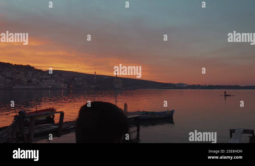 Sunset over Port in Lesvos Refugee Island, Two Homeless Syrian Men with ...