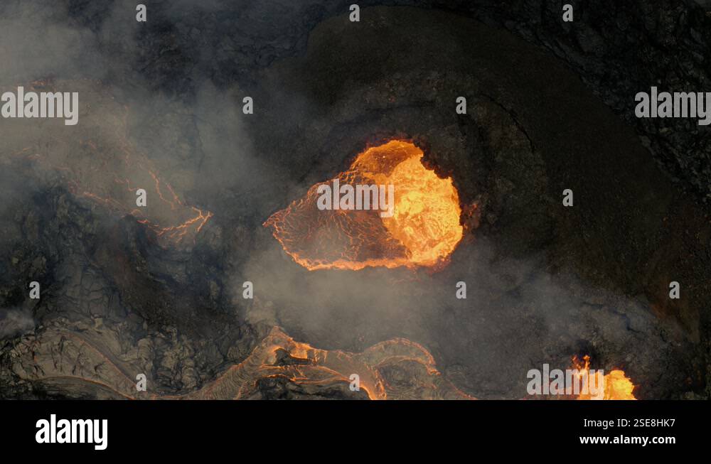 Drone shot top-down above a bubbling crater at the geldingadals volcano ...