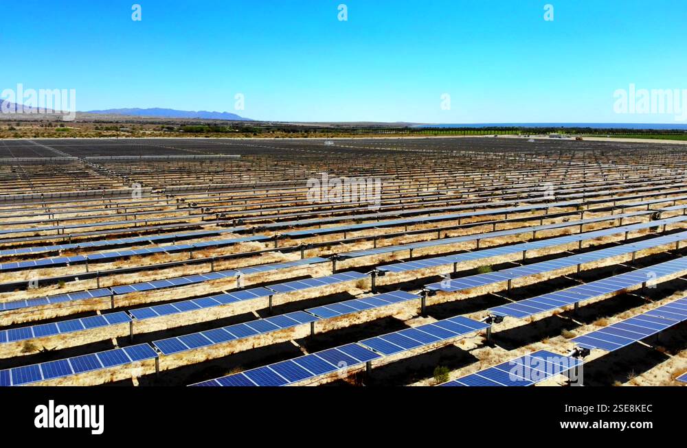 Solar panel photovoltaic farm aerial 4k drone rise above huge array of ...