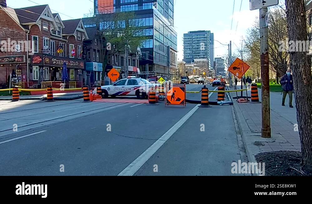 Police car and construction signs block off traffic on College Street ...