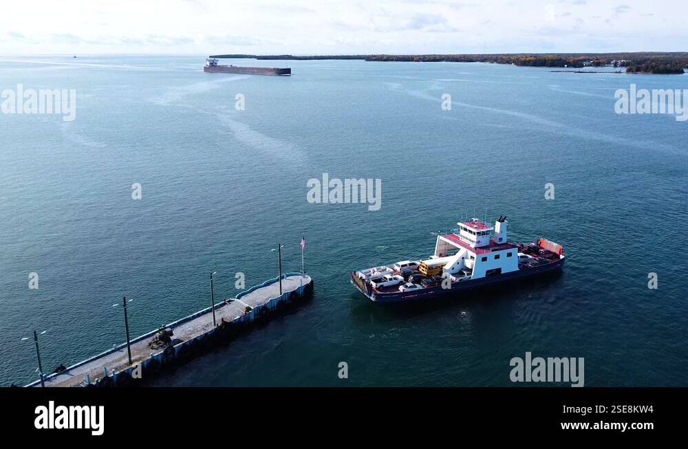 Ferry Boat leaving dock with cargo ship behind it Stock Video Footage ...