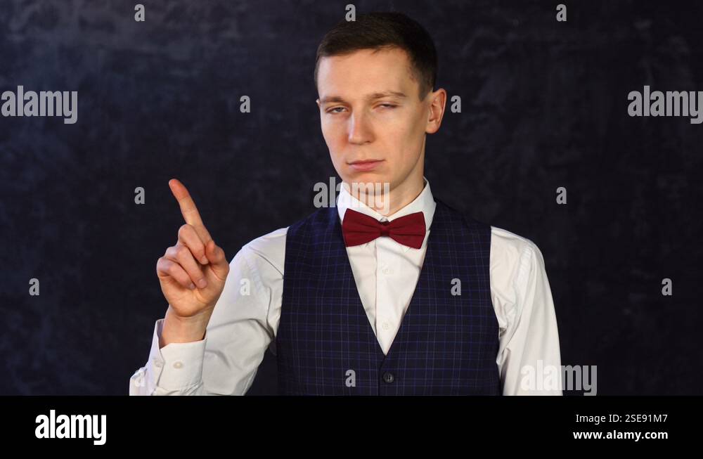 Man in a vest saying no by waving his finger. Fashion portrait of a ...