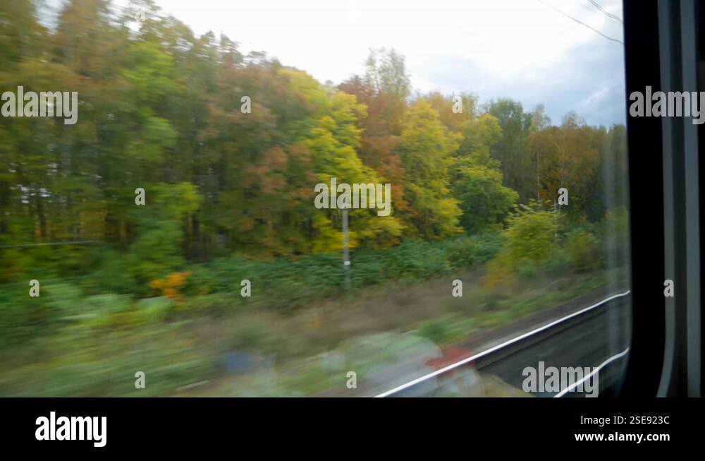 Window view from moving train of rails and beautiful autumn scenery ...