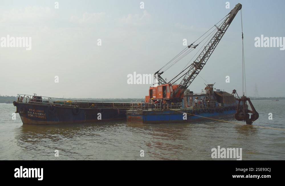 Mining or cleaning ocean or bay with a huge crane digging anchor ...