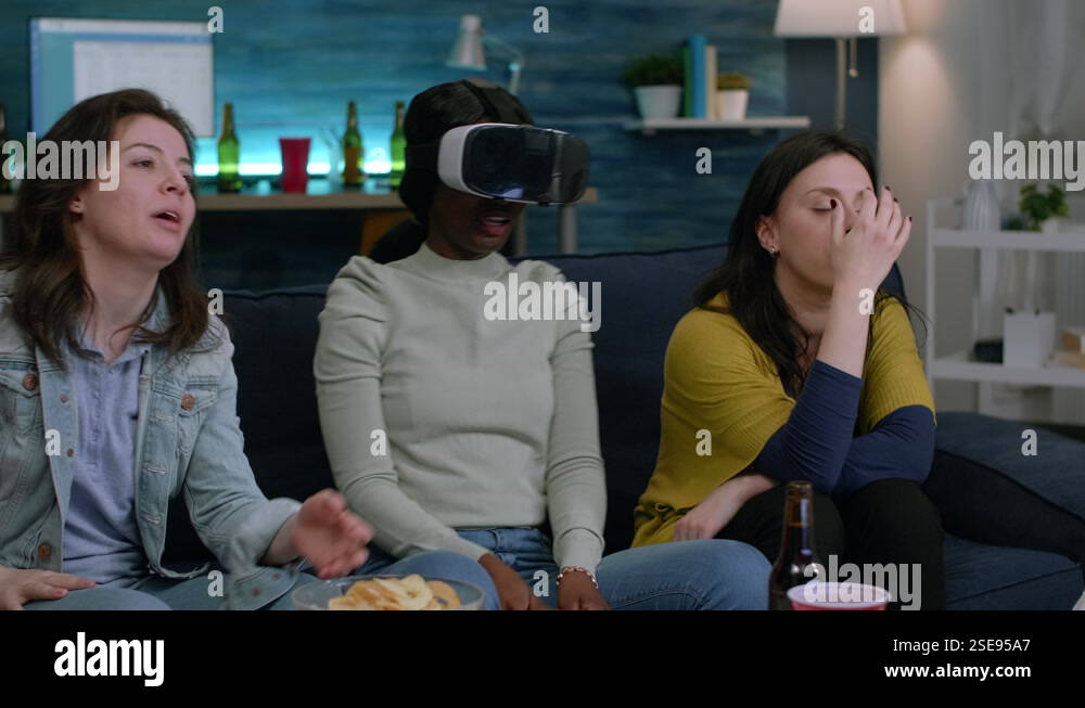 Mixed group of friends guiding afro american woman with virtual reality ...