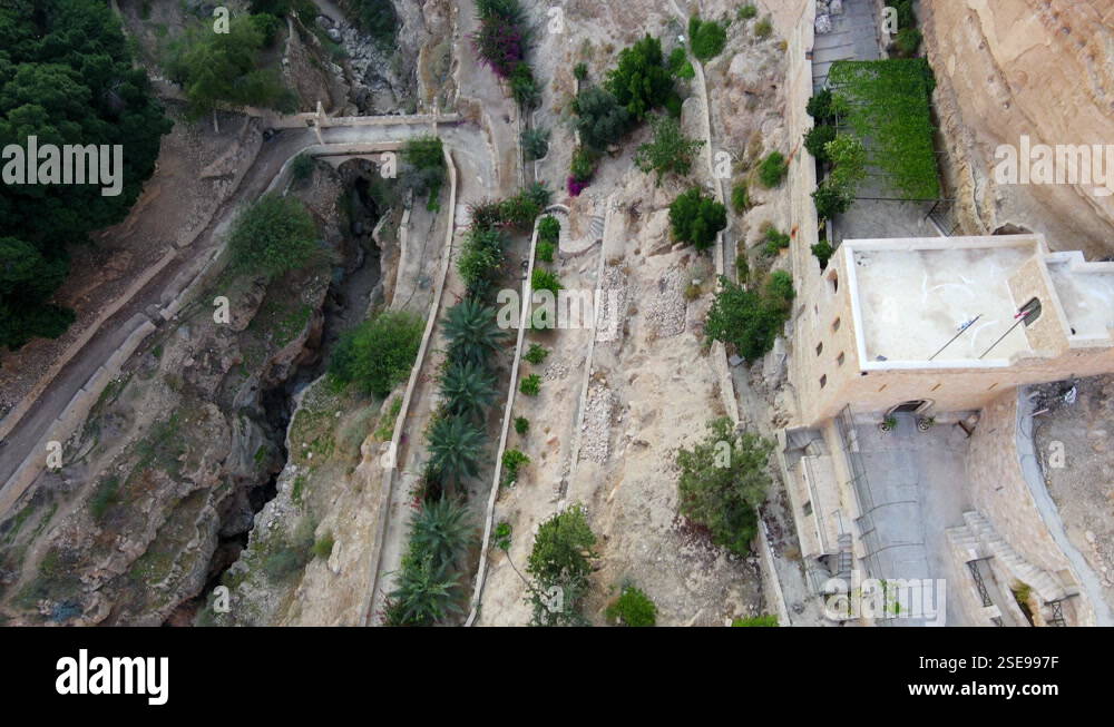 Aerial Tilt Up Shot Of Saint George Monastery Amidst Cliffs - West Bank ...