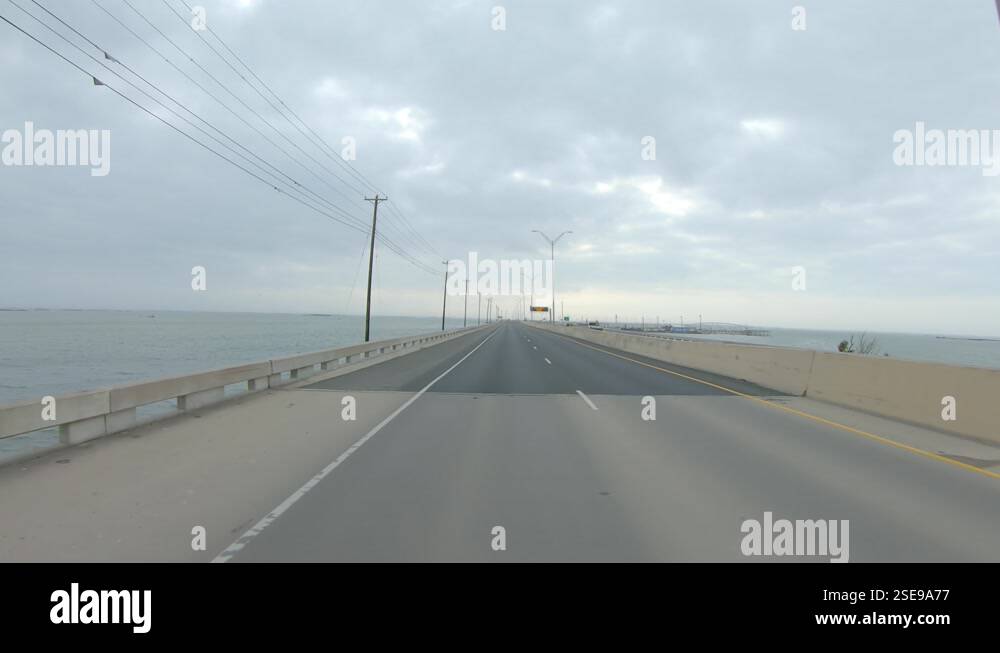 view thru rear window while driving on the JFK Memorial Causeway ...