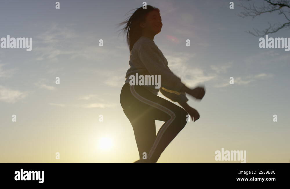 Young girl dancing and having fun outside in the countryside with the ...