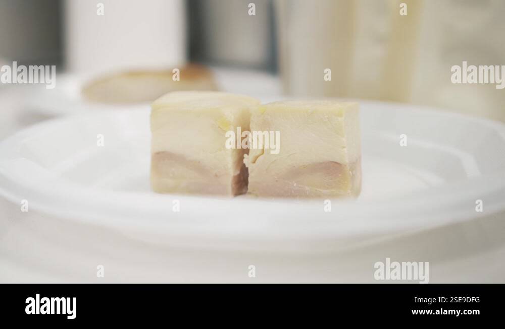 Meet in cubes plated on white restaurant plate. Molecular cuisine dish ...