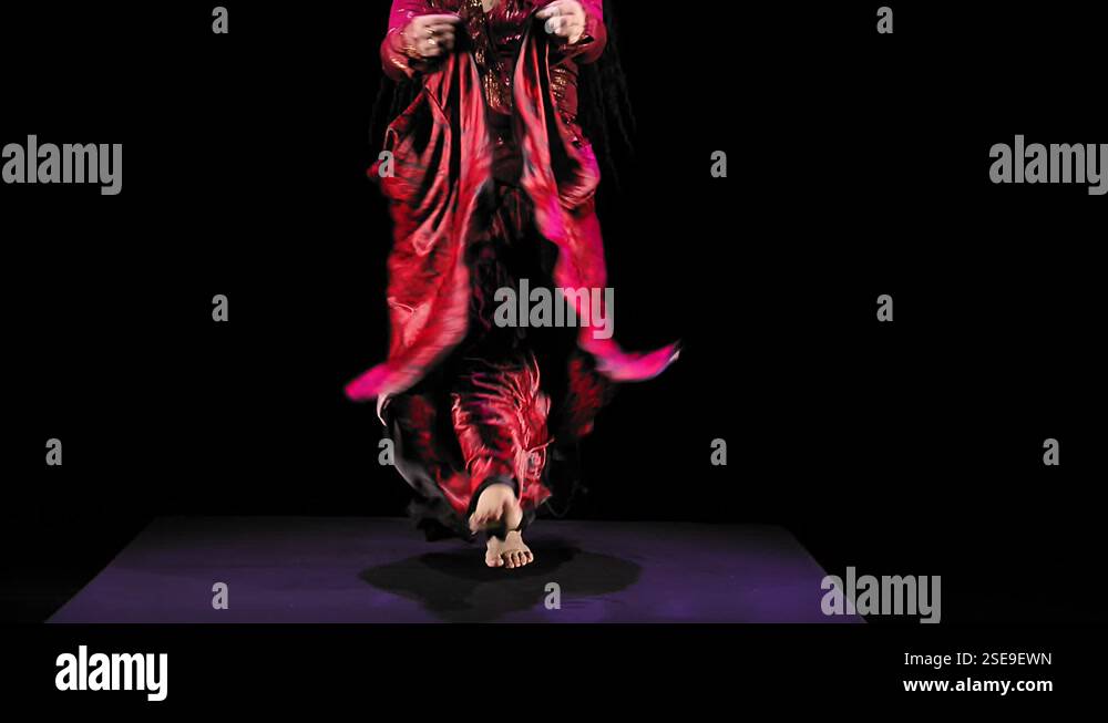 A barefoot gypsy woman without a face with long black hair in a red ...