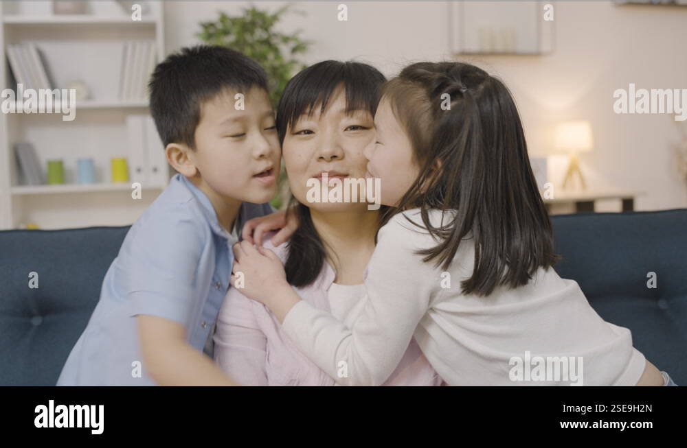 Sweet asian kids kissing mother on cheeks, parent and child relationship, family Stock Video ...