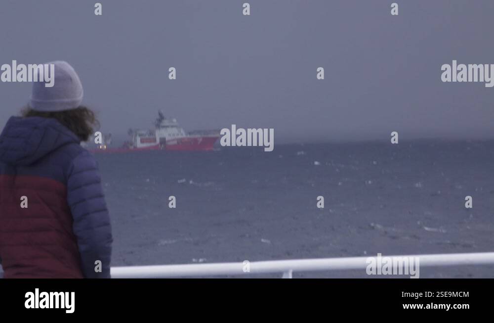 Young traveler waiting for rescue vessel to come and save them on a ...