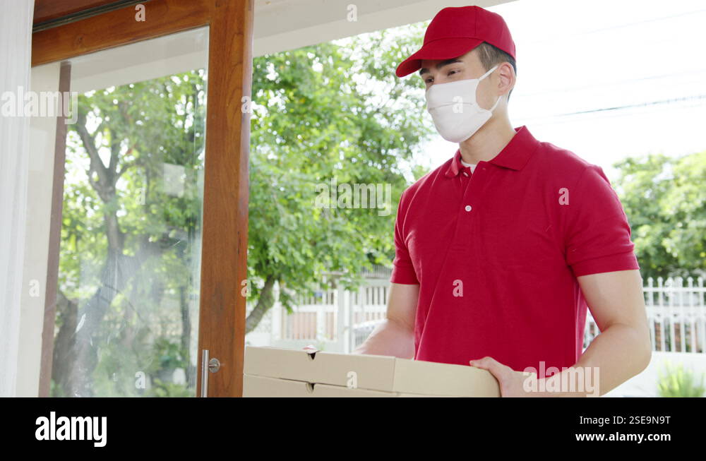 Postal delivery courier man wear face mask handling food box to ...