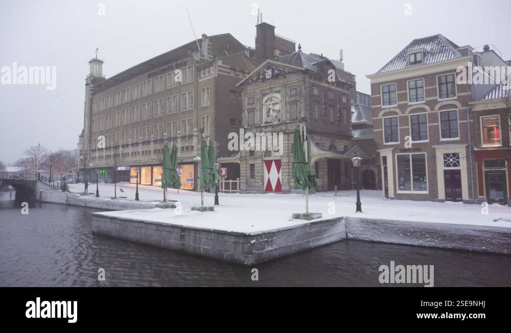 Leiden Waag restaurant on Rhine riverside in winter snow, Netherlands ...