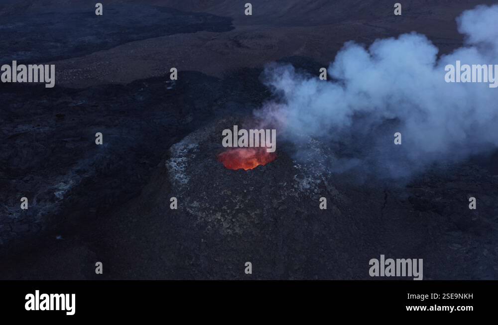 Active magma pit with smoke rising from opening, dark basalt surface Stock Video Footage - Alamy