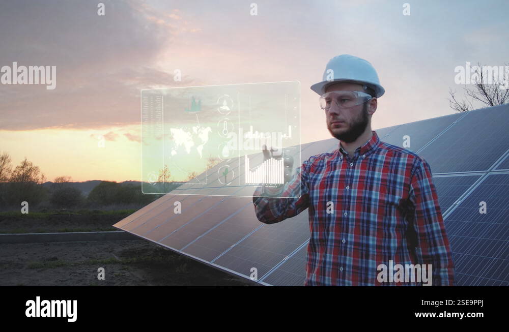 Engineer in front of solar panel works on futuristic table HUD display ...