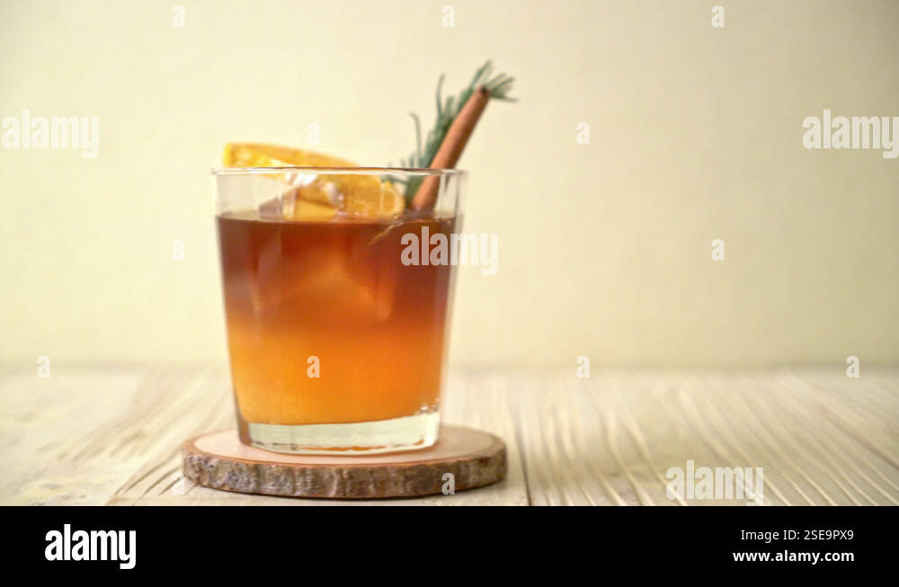 A glass of iced americano black coffee and layer of orange and lemon ...