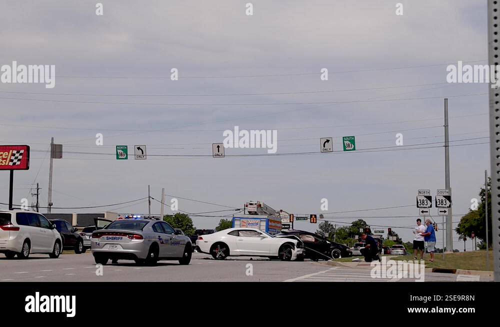 A wreck involving a white camera and black sports car and police on the ...