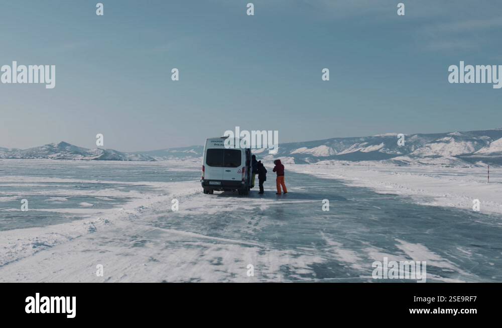 BAIKAL, IRKUTSK REGION, RUSSIA - MARCH 18, 2021: Men and women board a ...