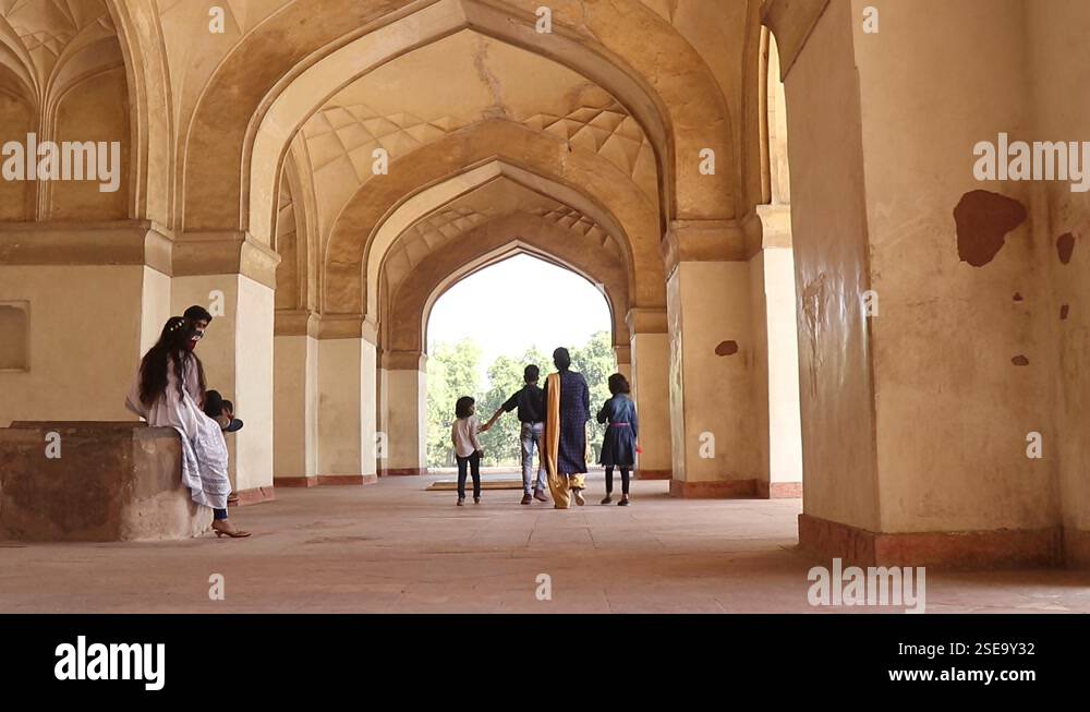 Visitors walk inside the campus of the Tomb of Akbar Monument in Agra ...