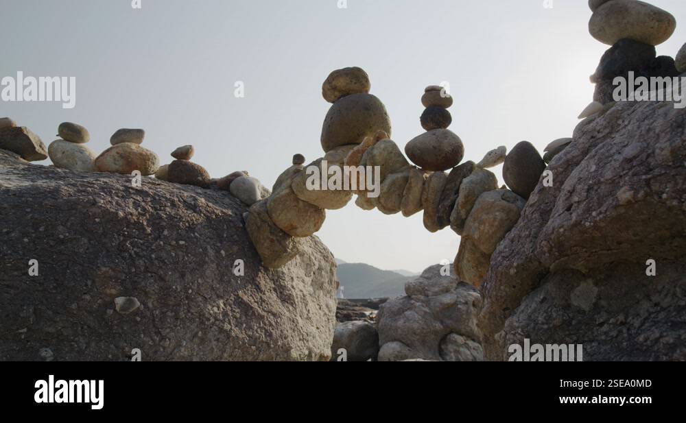 Arch of pebbles in balancing on the sea coast Stock Video Footage - Alamy