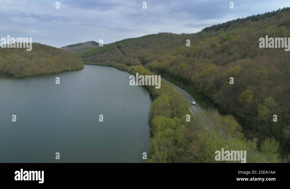 Peaceful Scenery With Calm Waters Of The Lake And Vehicles Driving On ...