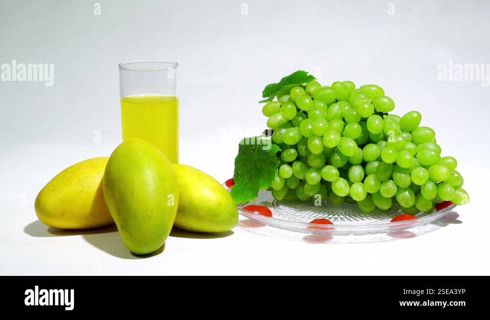 Green grapes, mangoes and juice on white background Stock Video Footage ...