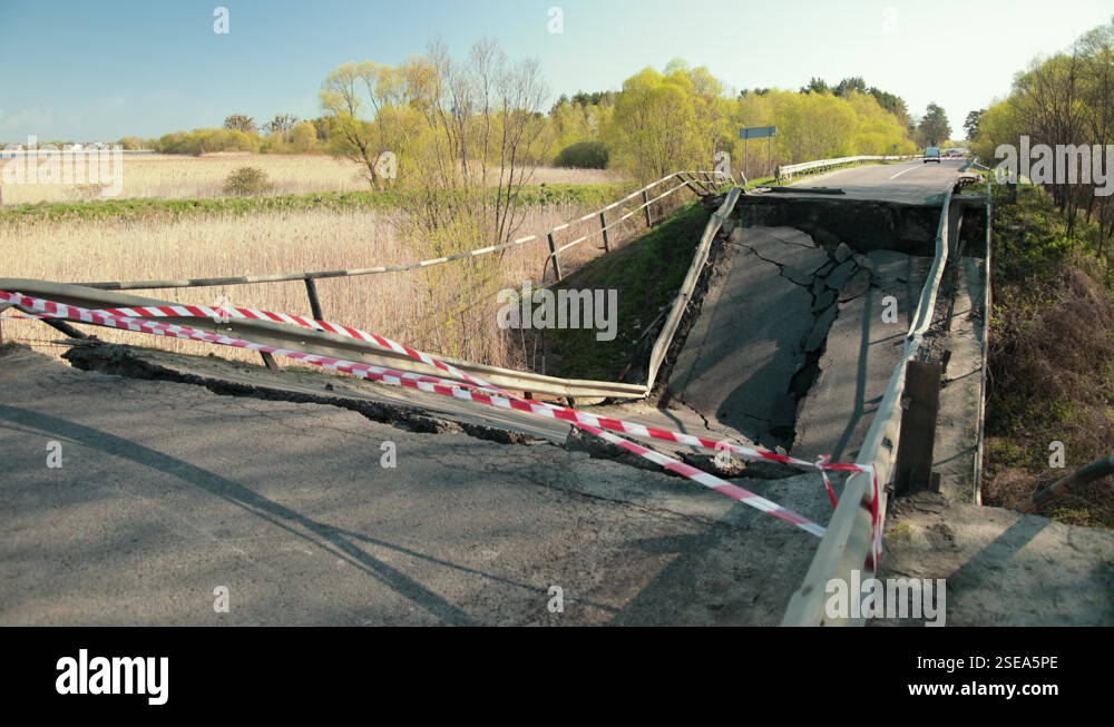 Flood damaged closed highway road, bridge. Cracked asphalt after ...