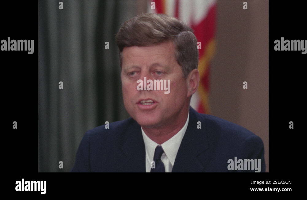 1960s Washington DC: Close-up of President John F. Kennedy sits at desk ...