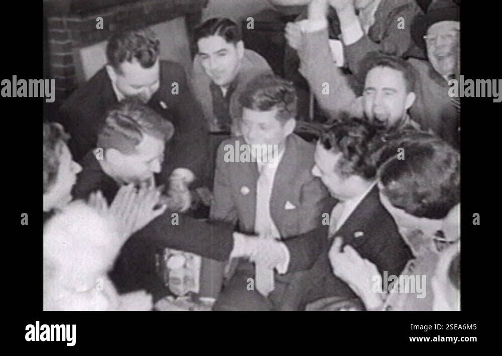 1950s: John F. Kennedy with crowd of men. Men cheering around Kennedy ...