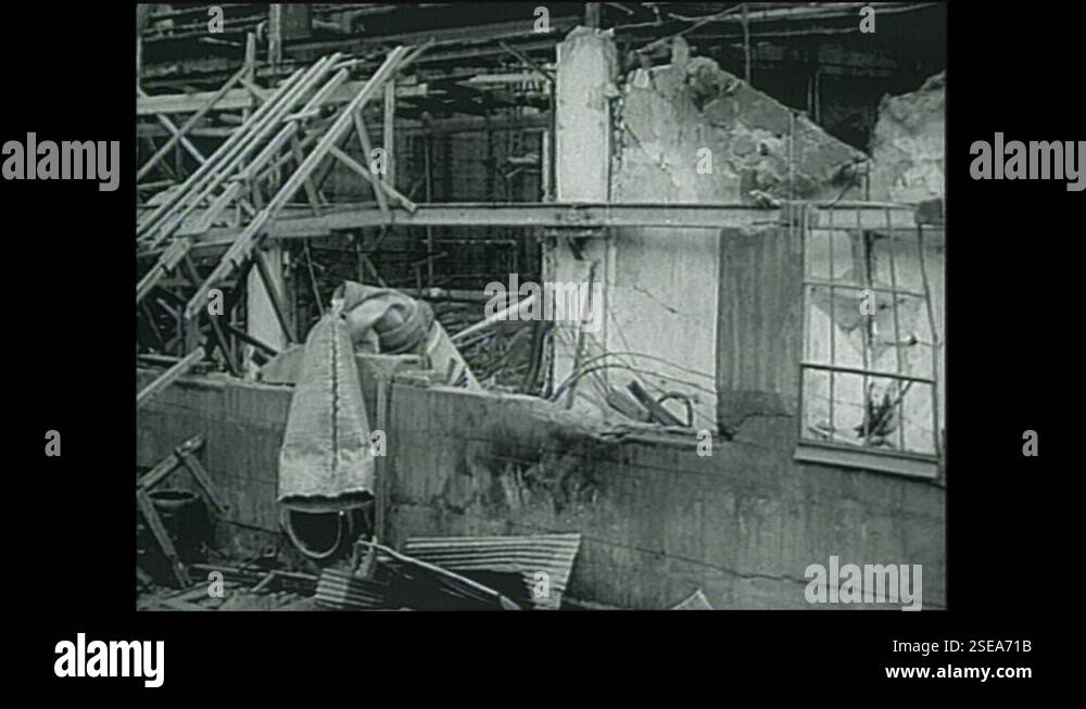 1940s: View of destroyed factory. Man working in lab. Engine blasting ...