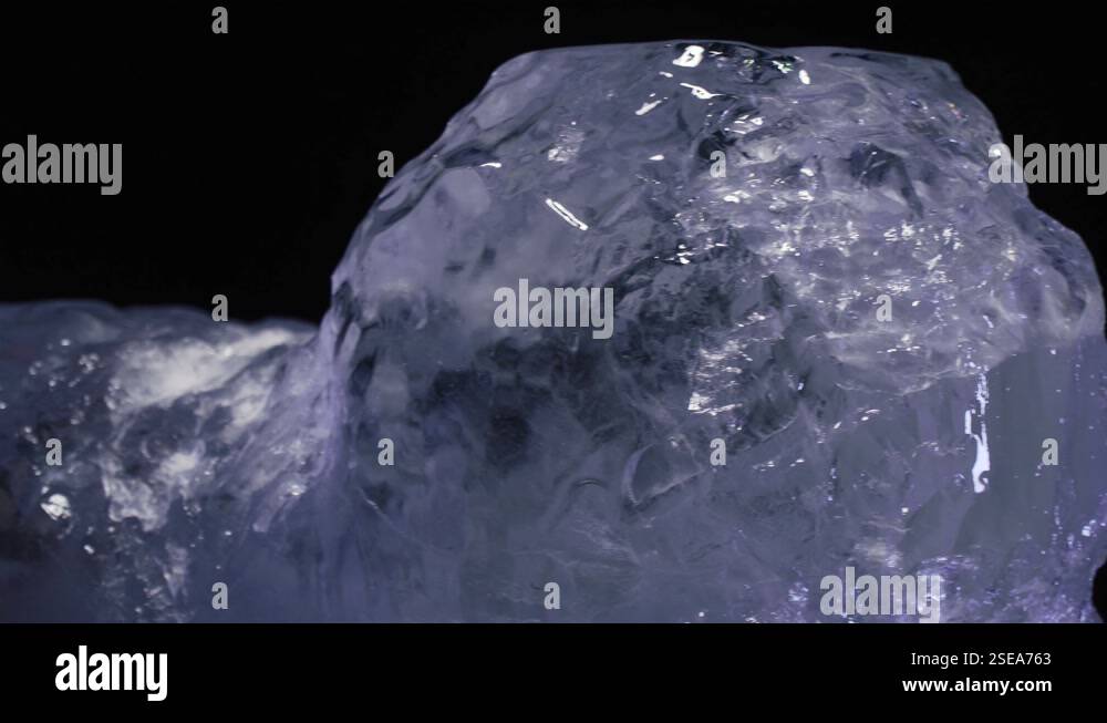 Professional artist is creating details on an ice sculpture with a ...