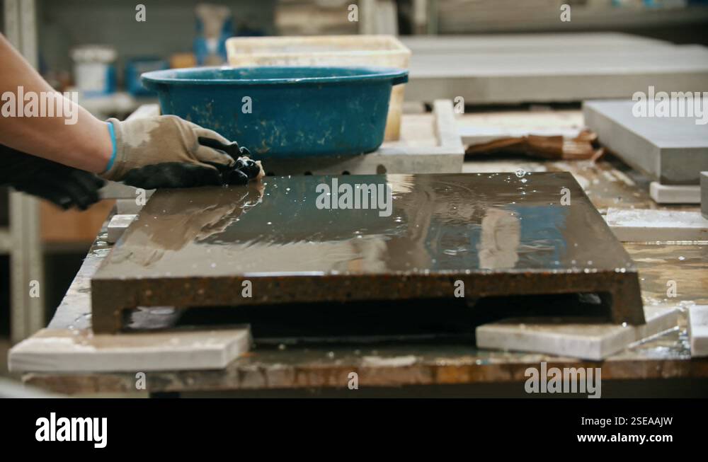 A man worker washing a concrete surface with a rag and water Stock ...