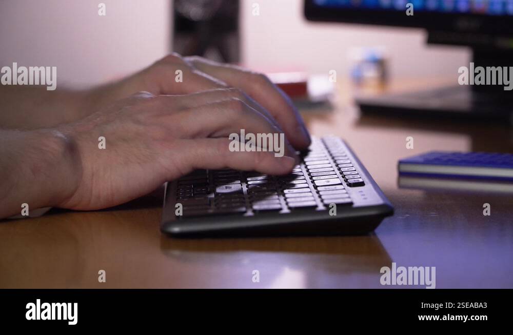 A man is typing on a keyboard. Freelancer works from home Stock Video ...