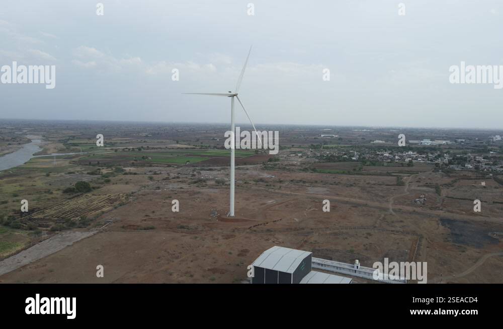 Cinematic aerial view of large wind turbines producing clean ...