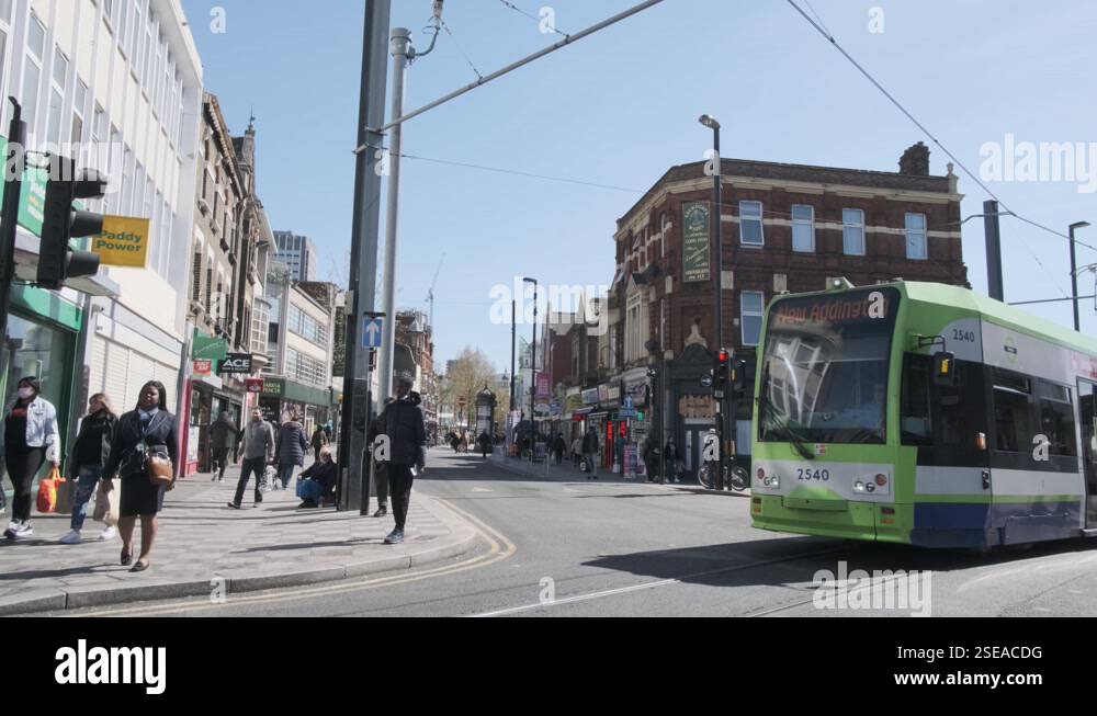 London tram passing through intersection in croydon old town follow ...