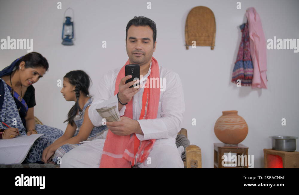 Indian villager taking a phone call about receiving money - financial ...