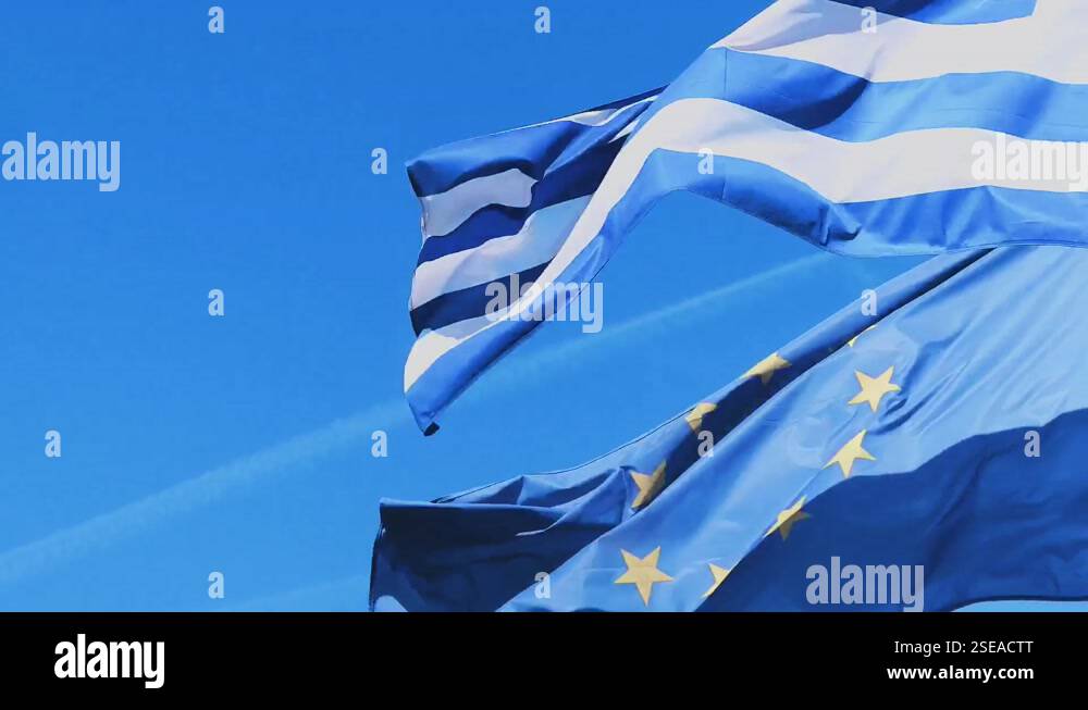 Greek and European Union flags and blue sky on a windy day, travel and ...