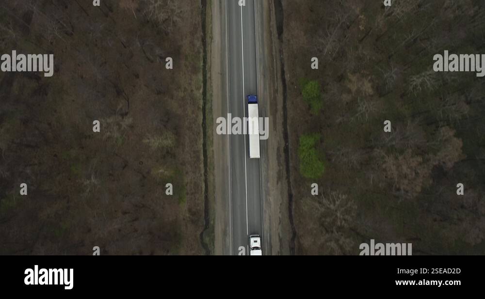 One Semi Truck with white trailer and cab driving, traveling alone on ...