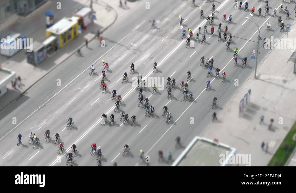 Many cyclists ride along the road. Bike ride on the street handheld ...