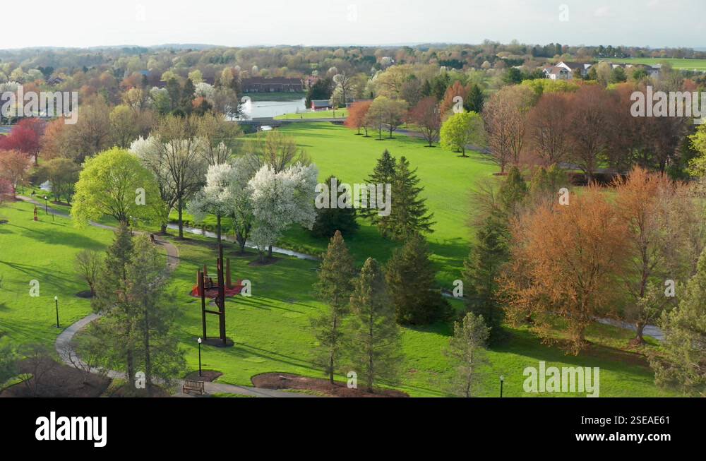 Beautiful aerial of walking trail, path through park in full bloom ...