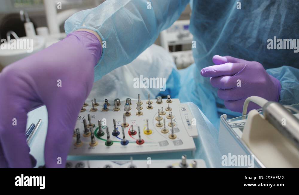 Close-up of a dental surgeon preparing a working tool for implanting a ...