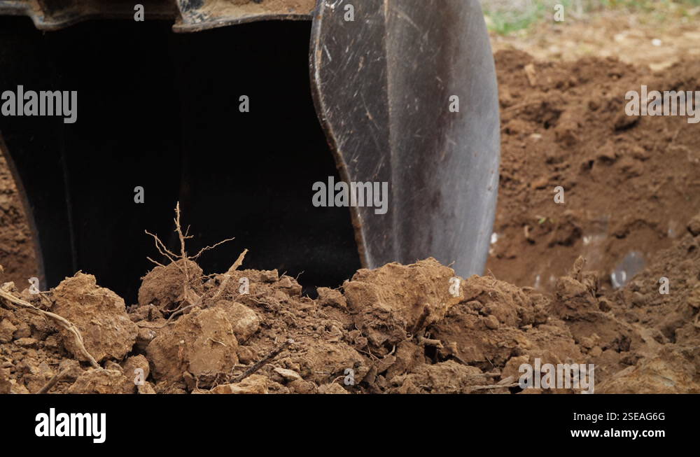 Excavator working in a field of a Farm. Backhoe operating in a Land on ...